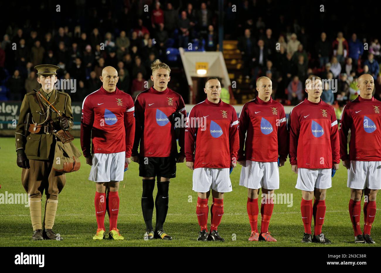 British Army team players accompanied by an officer, left, dressed in ...