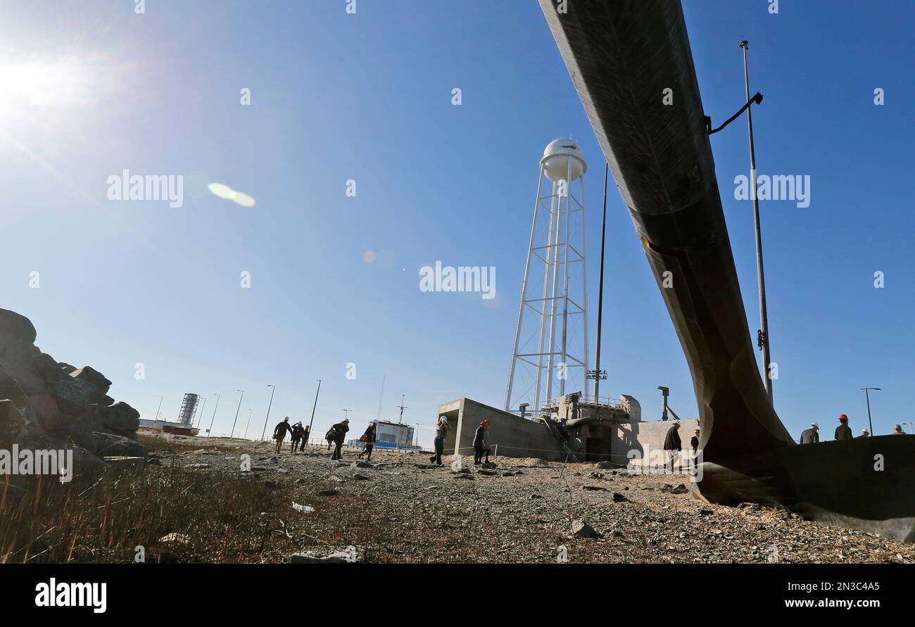 A collapsed lightening arrester tower leans on a seawall at the launch ...