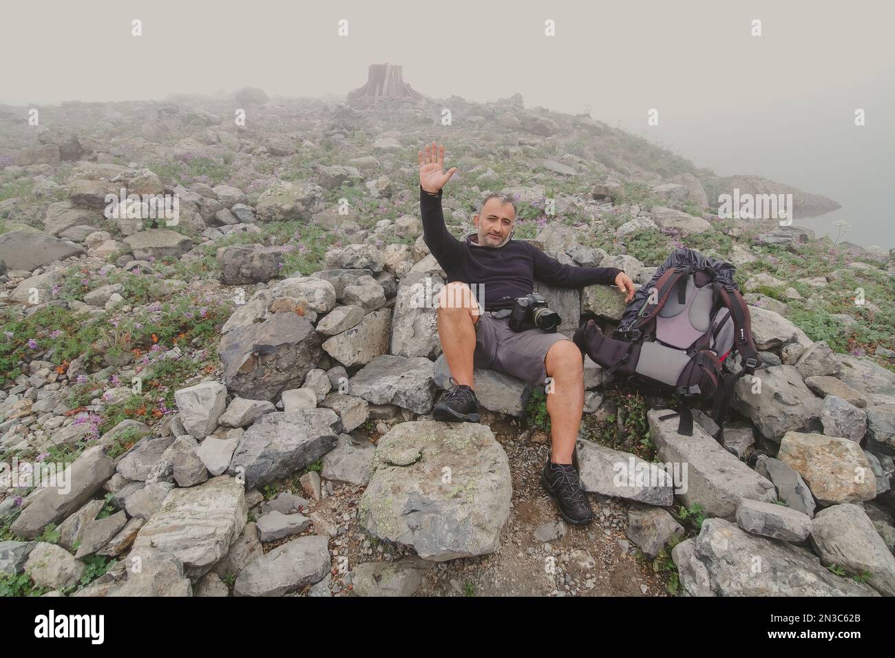 Man wearing backpack climbing mountain hi-res stock photography and ...