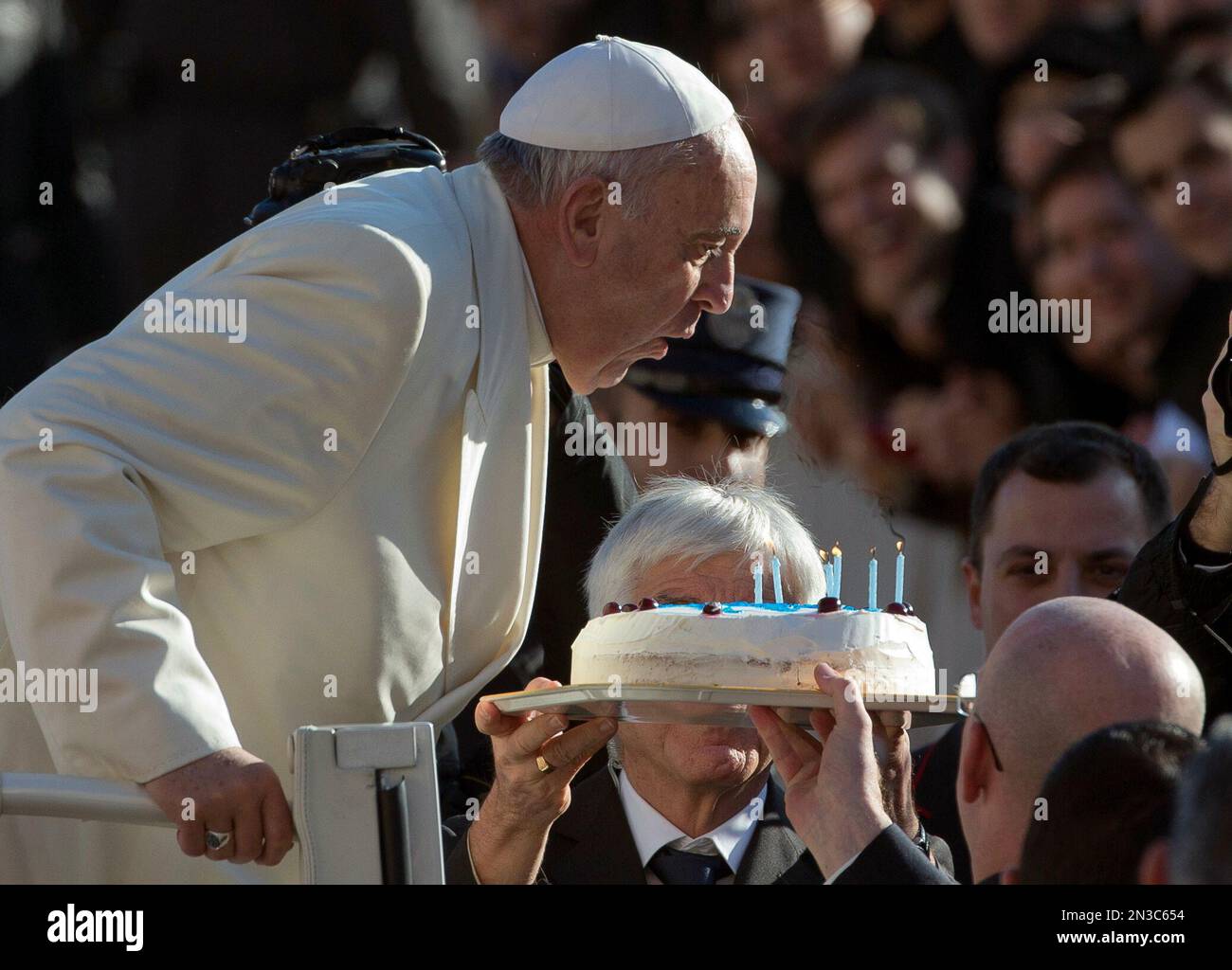 Pope Francis blows candles on a birthday cake on the occasion of his ...
