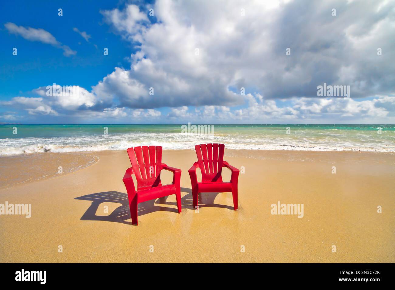 Red, beach chairs beckon on the sandy beach at Baldwin Beach on the ...