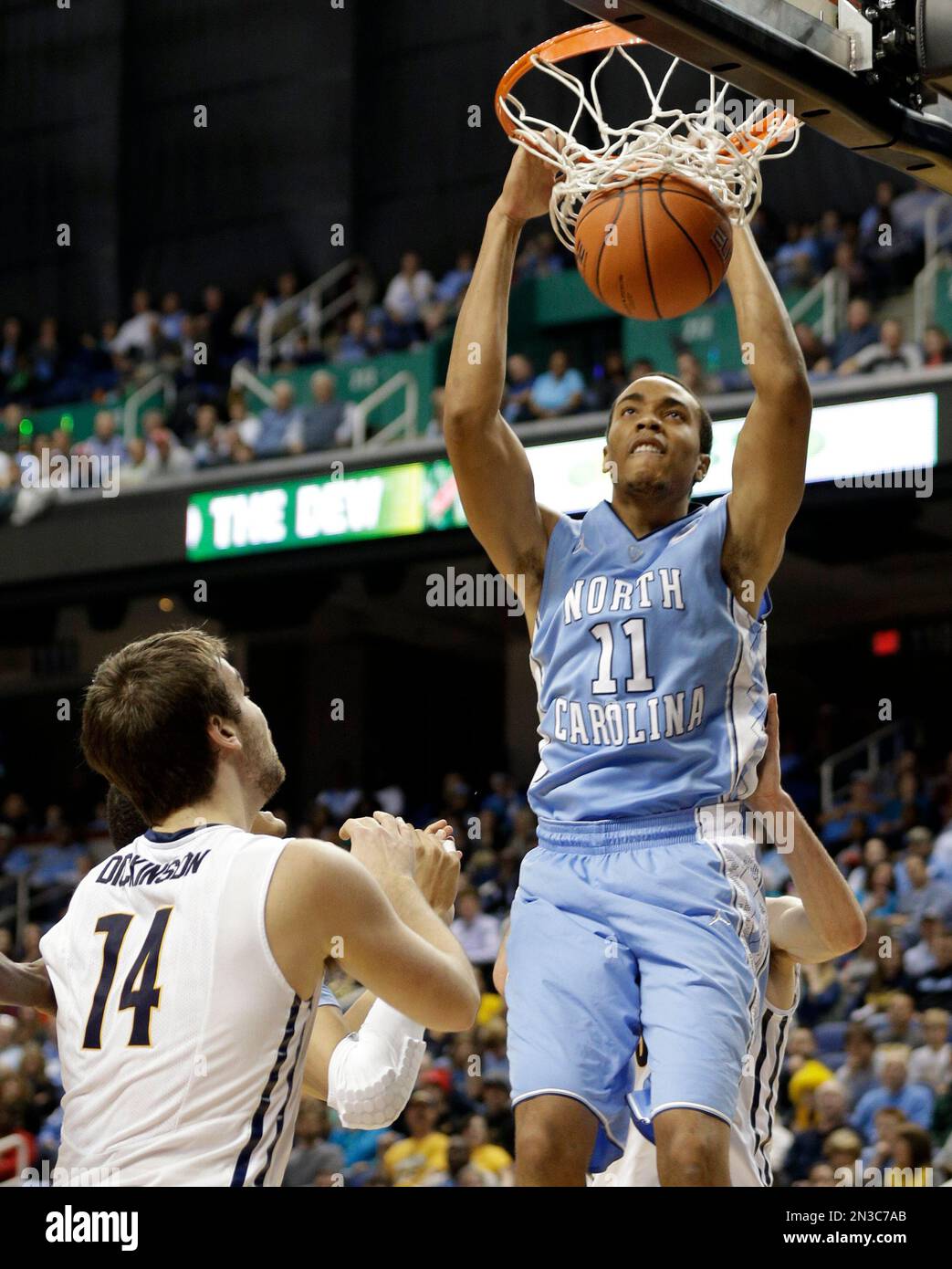 North Carolina's Brice Johnson (11) dunks over UNC Greensboro's Ben Dickinson (14) during the ...