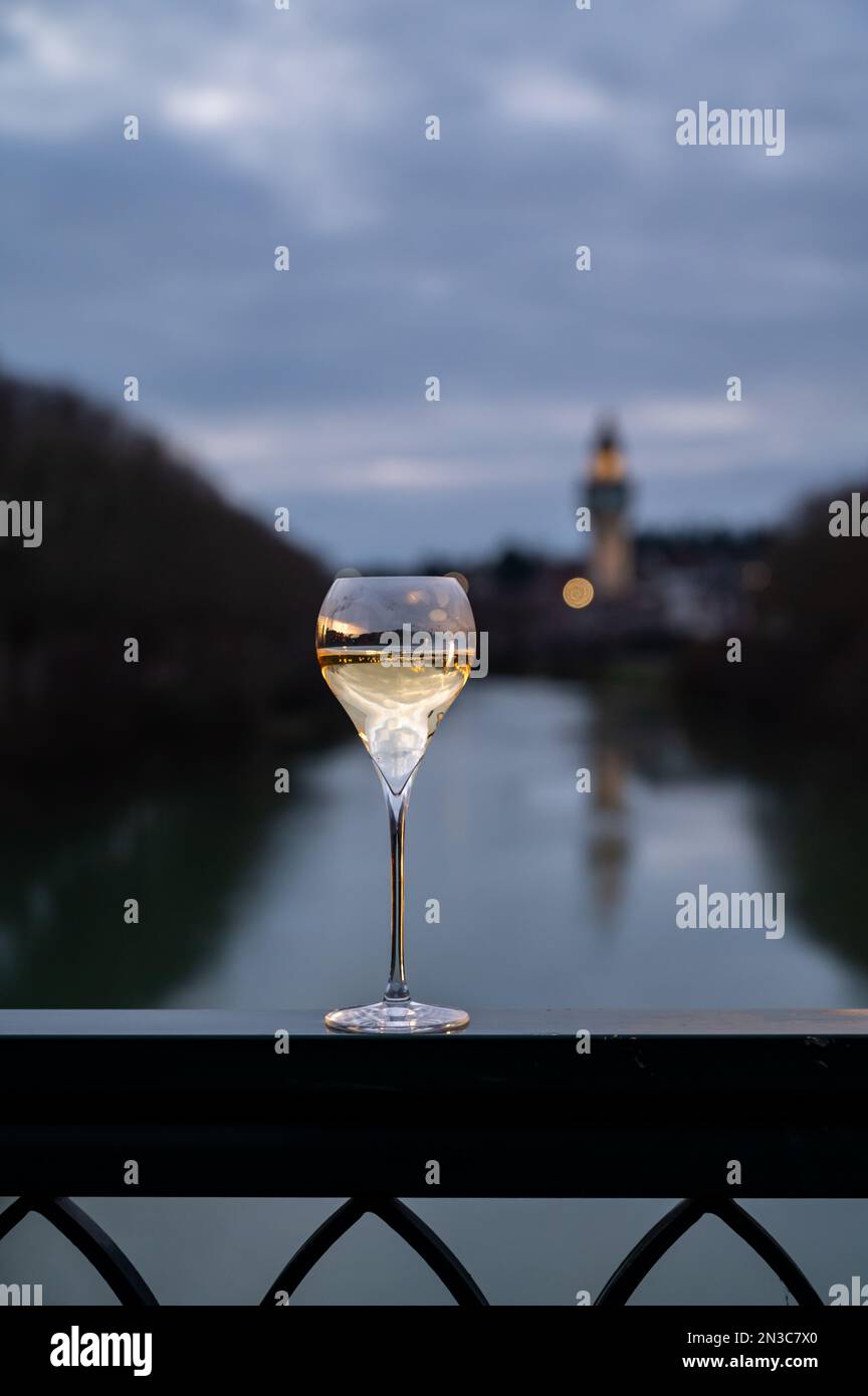 Glass of french sparkling white wine with bubbles champagne outdoor ...