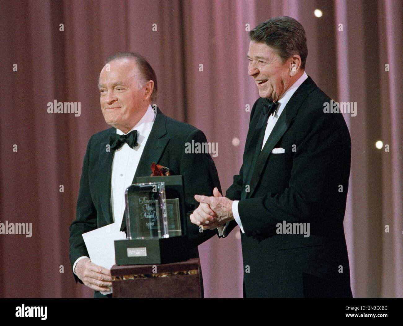 President Reagan applauds comedian Bob Hope after he was presented the ...
