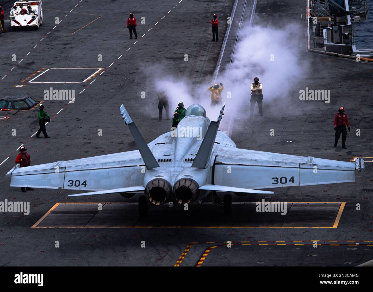 230207-N-MH015-1124 SOUTH CHINA SEA (Feb. 7, 2023) A U.S. Navy Sailor directs an F/A-18E Super ...