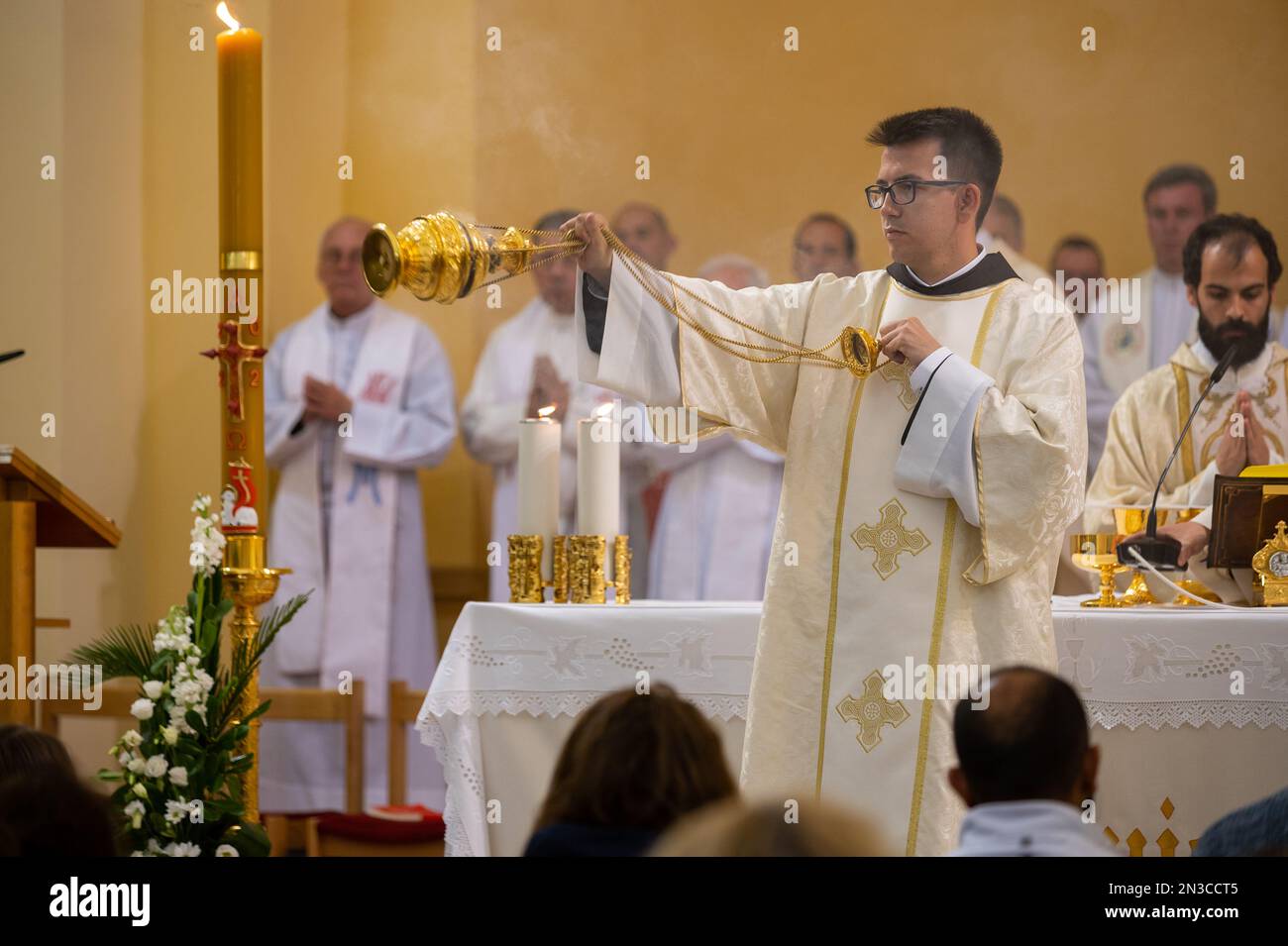 A priest incensing the faithful during the Holy Mass on the Easter ...
