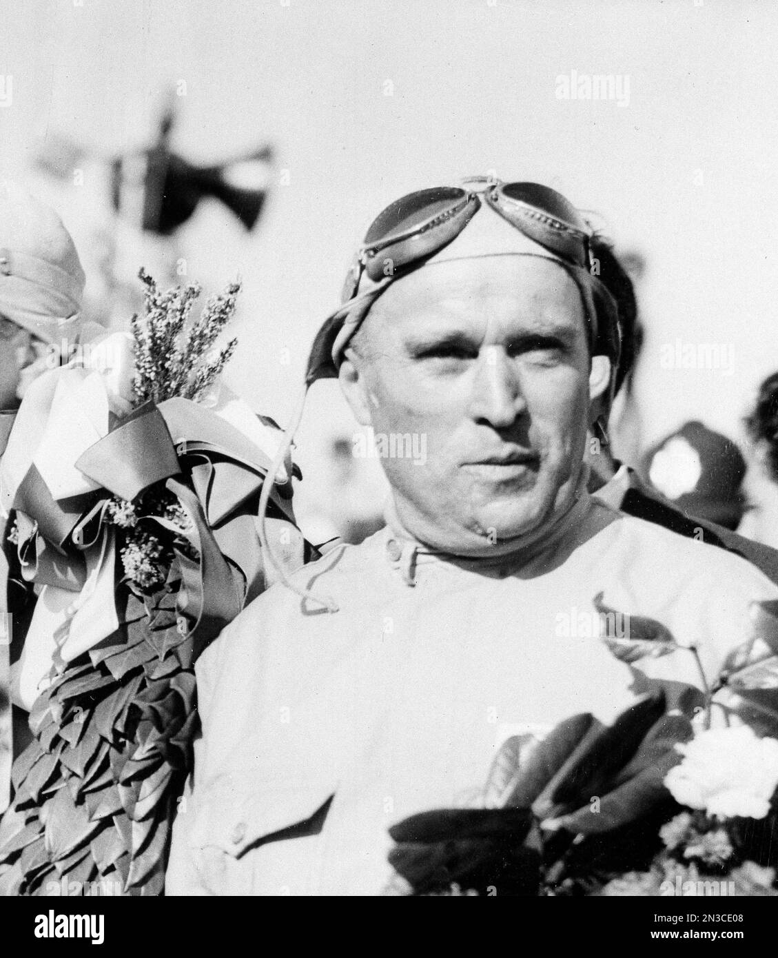 Italian Grand Prix driver Luigi Fagioli poses with second-place laurels ...