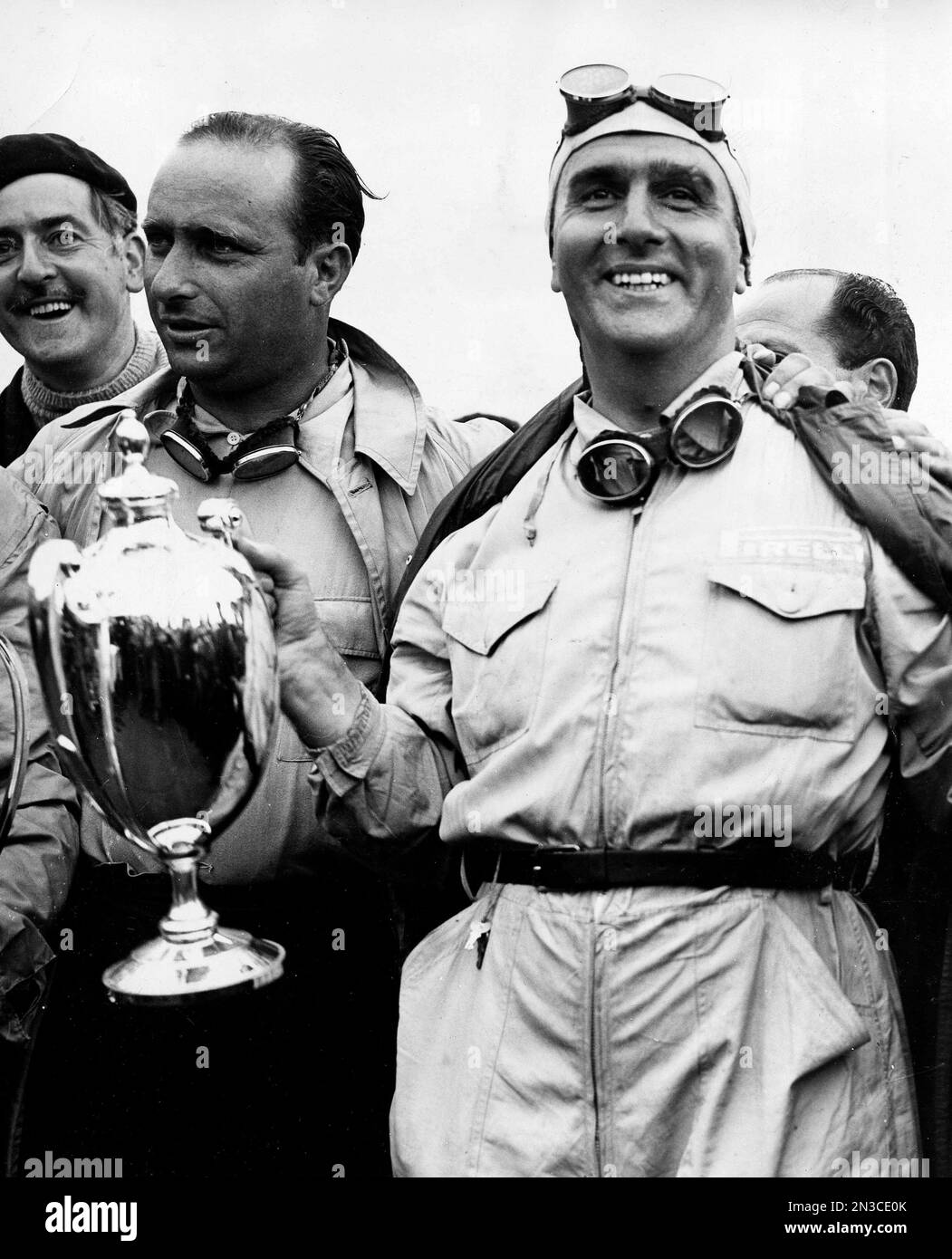 Giuseppe Farina of Italy smiles as he clasps the International trophy ...