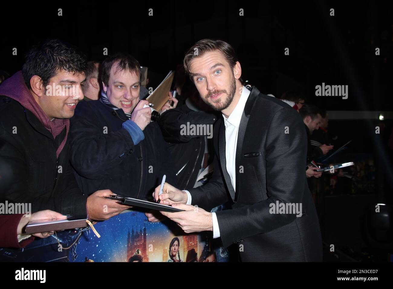 Actor Dan Stevens signs autographs upon arrival for the premiere of the ...