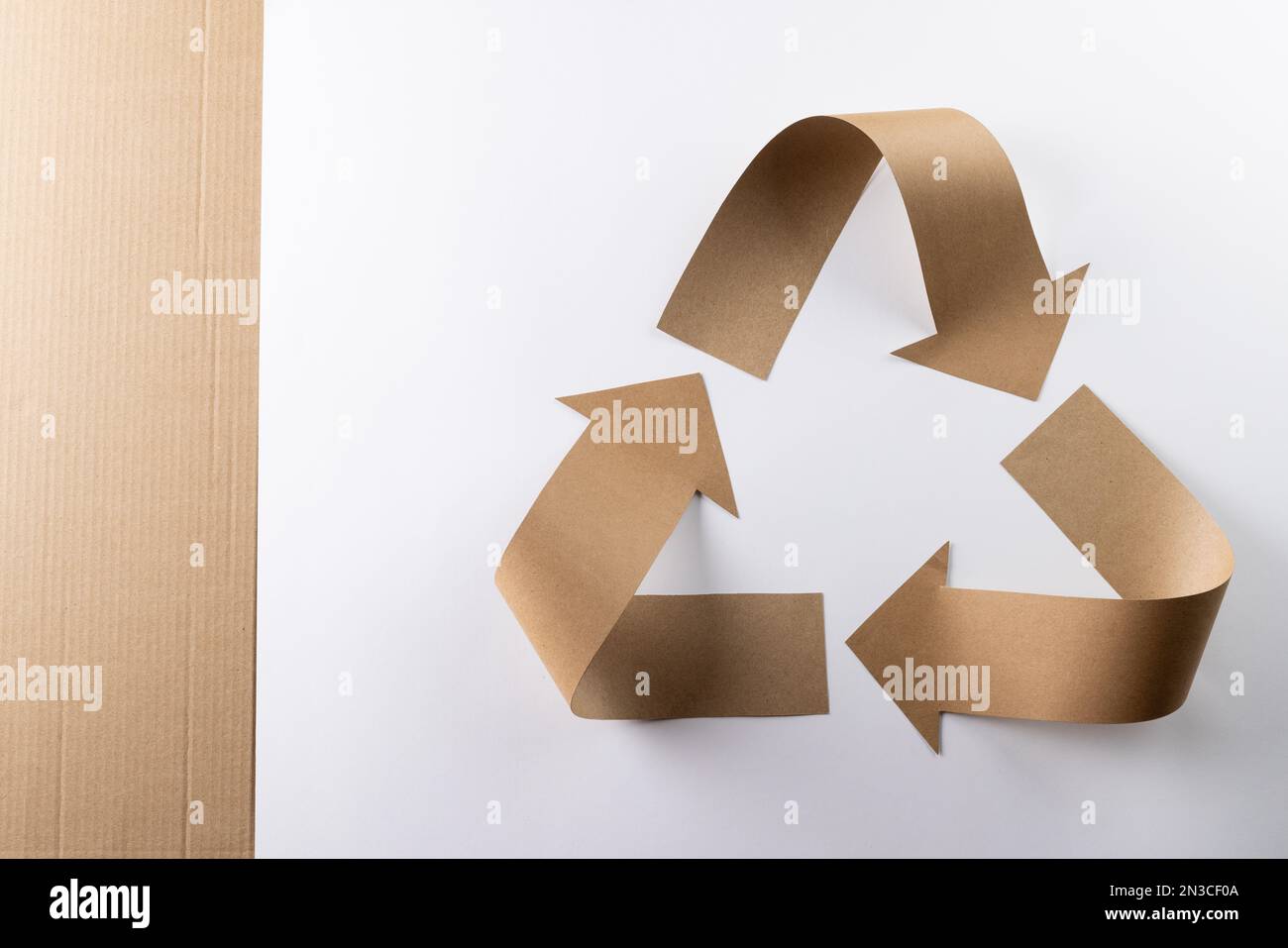 Close up of recycling symbol of paper arrows and carton on white ...