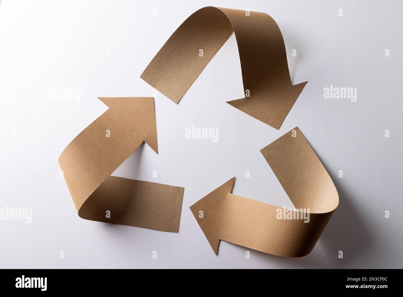 Close up of recycling symbol of carton arrows on white background with ...