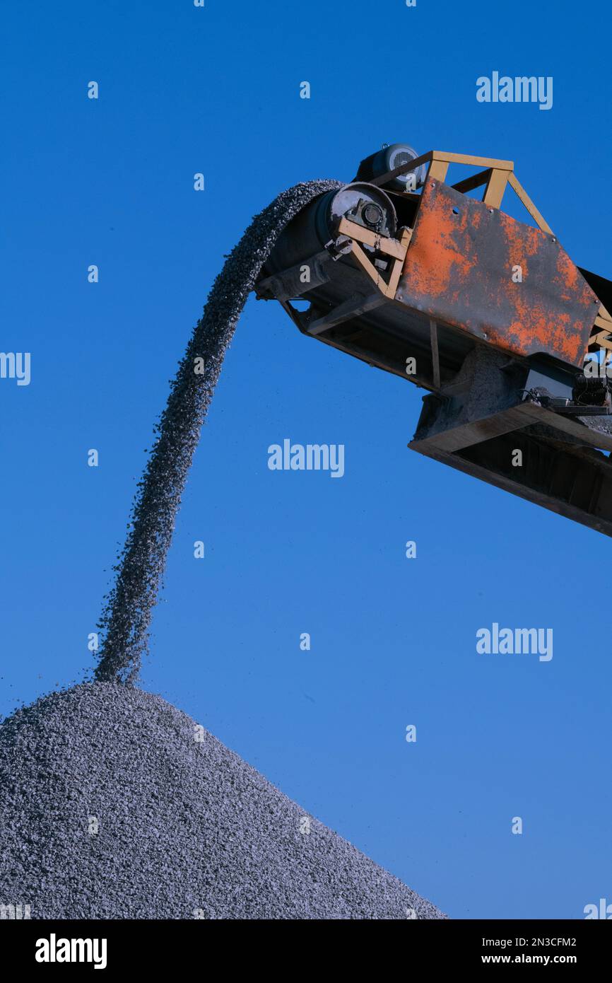 6,200 tons of concrete aggregate are unloaded from a barge delivery at ...