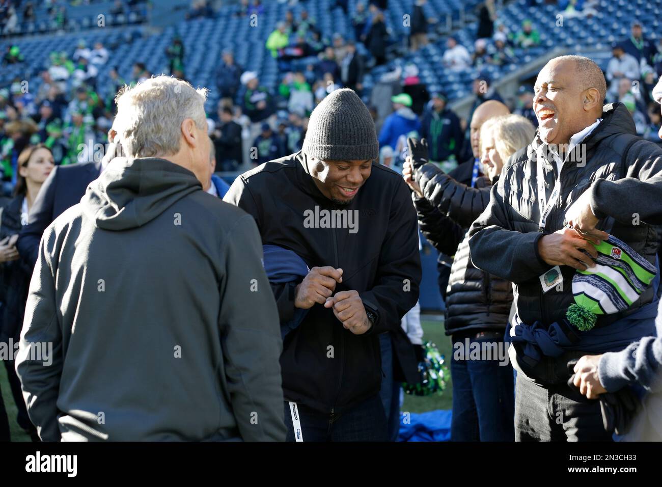 Former Seattle Mariners' Ken Griffey Jr., second left, smiles as he ...