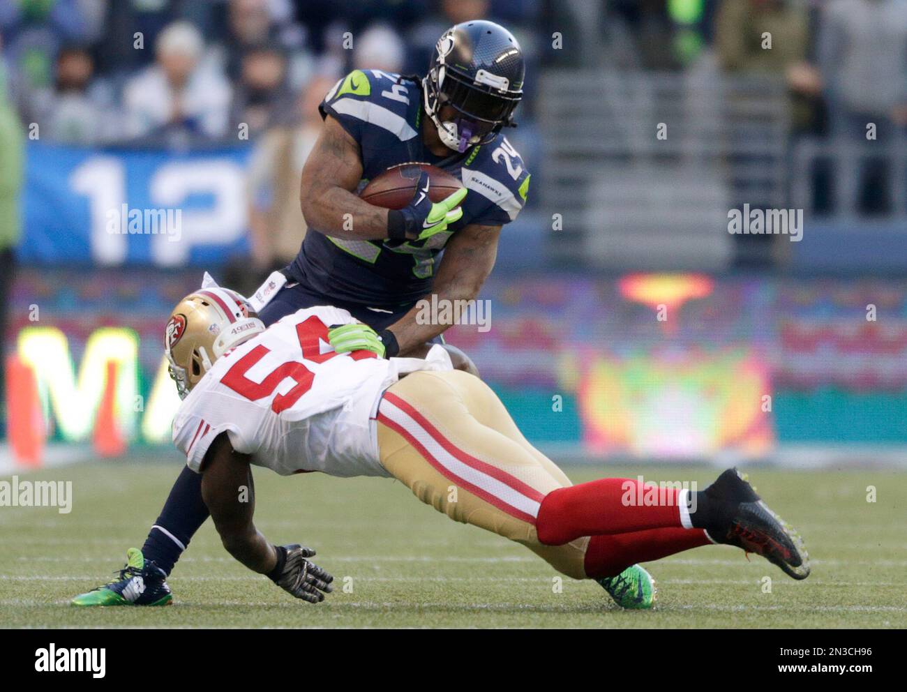 Seattle Seahawks' Marshawn Lynch is hit by San Francisco 49ers'Nick ...