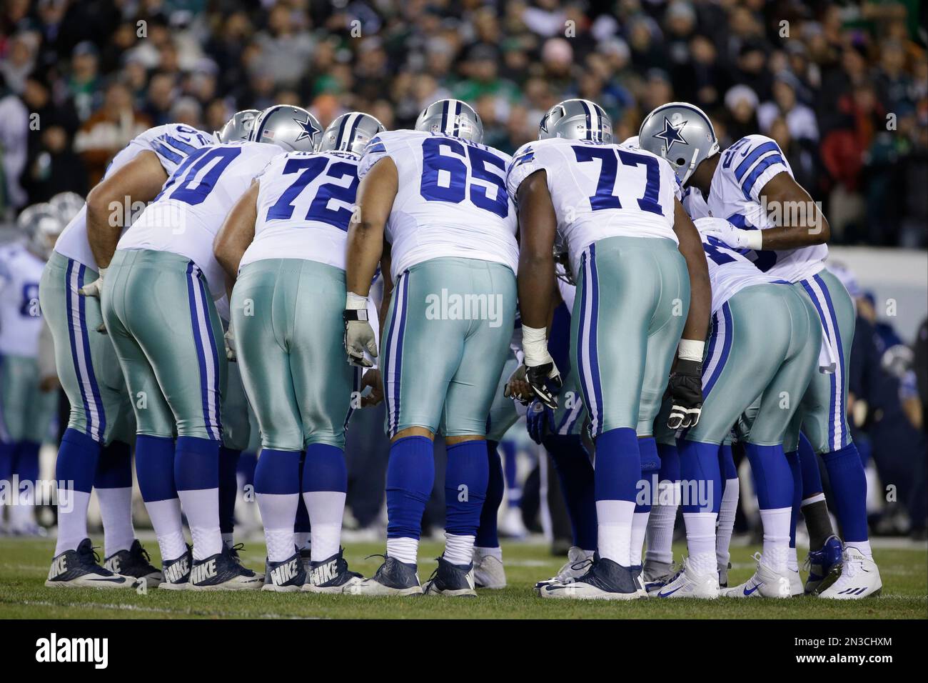 The Dallas Cowboys huddle during the first half of an NFL football game ...