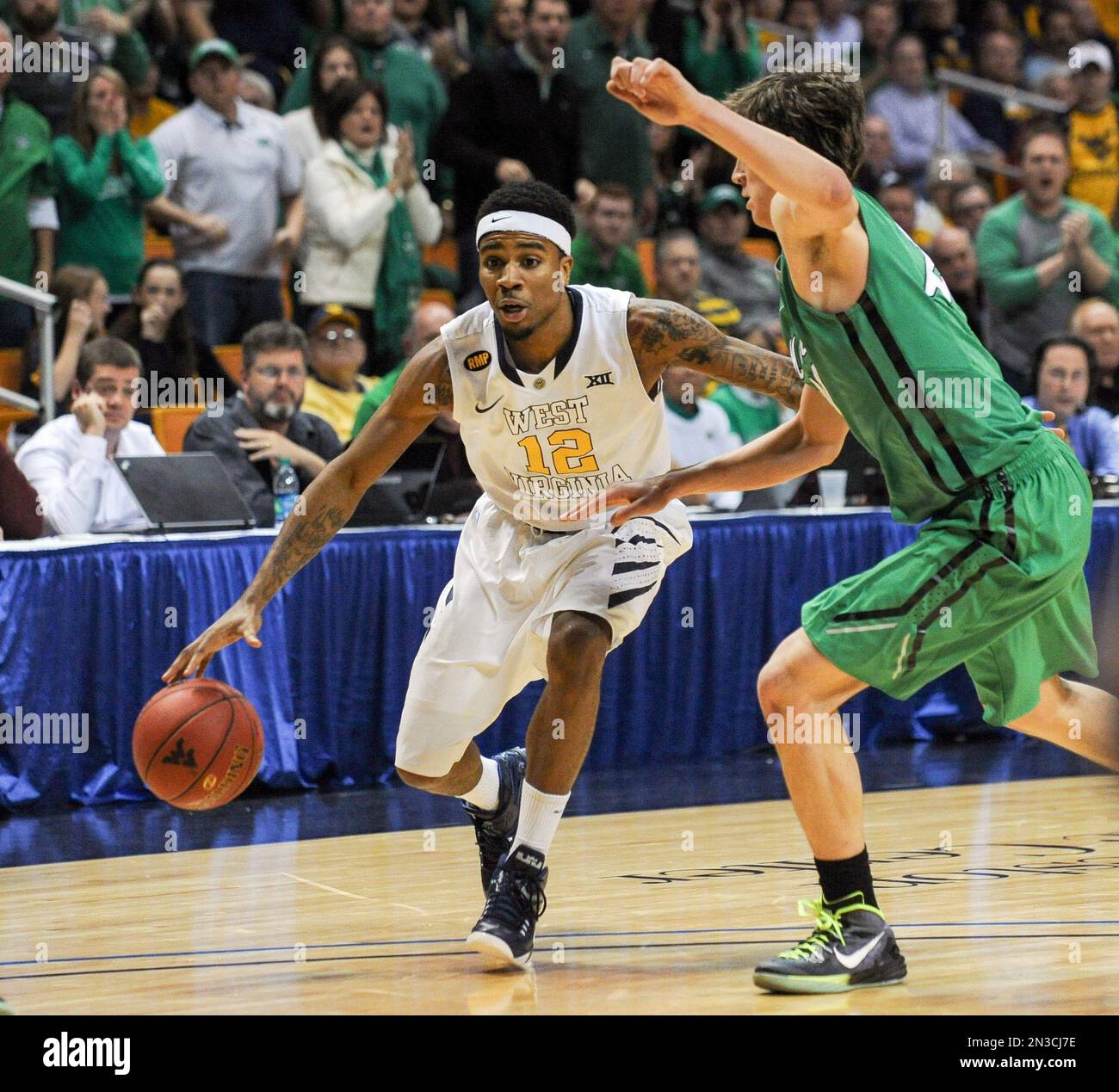 West Virginia's Tarik Phillip (12) drives down the court during the ...