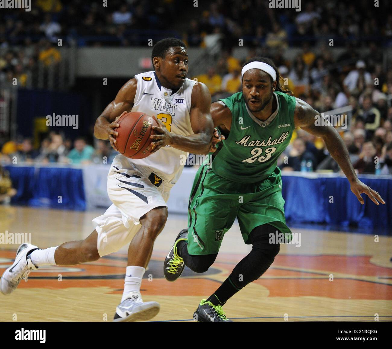 West Virginia's Juwan Staten (3) drives to the basket as Marshall's ...