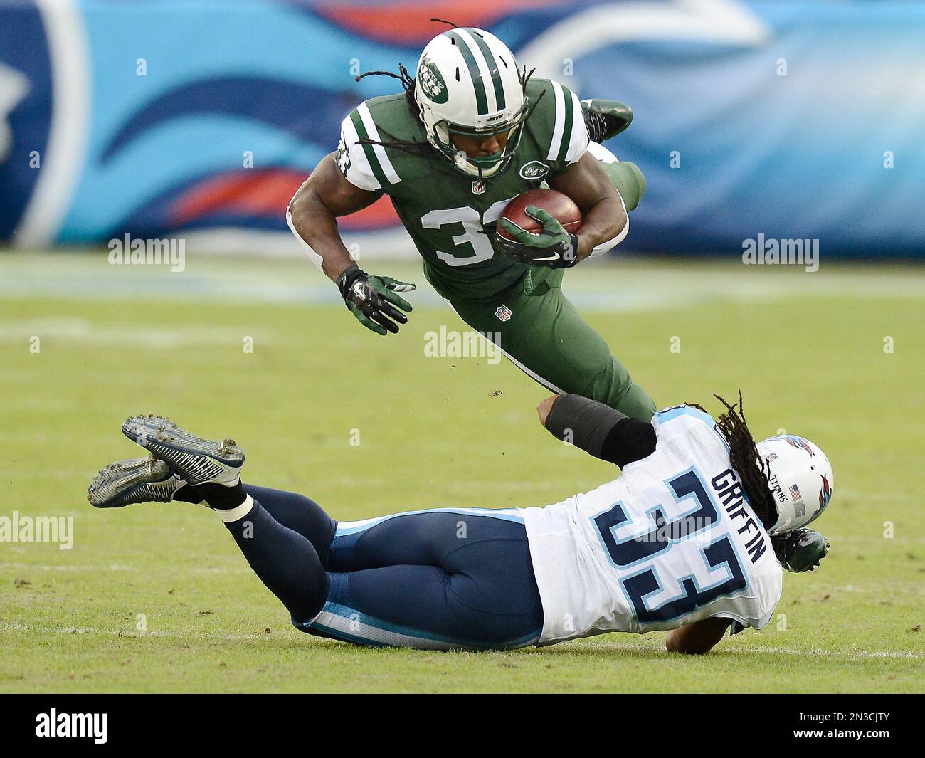 New York Jets running back Chris Ivory, top, is tripped up by Tennessee ...