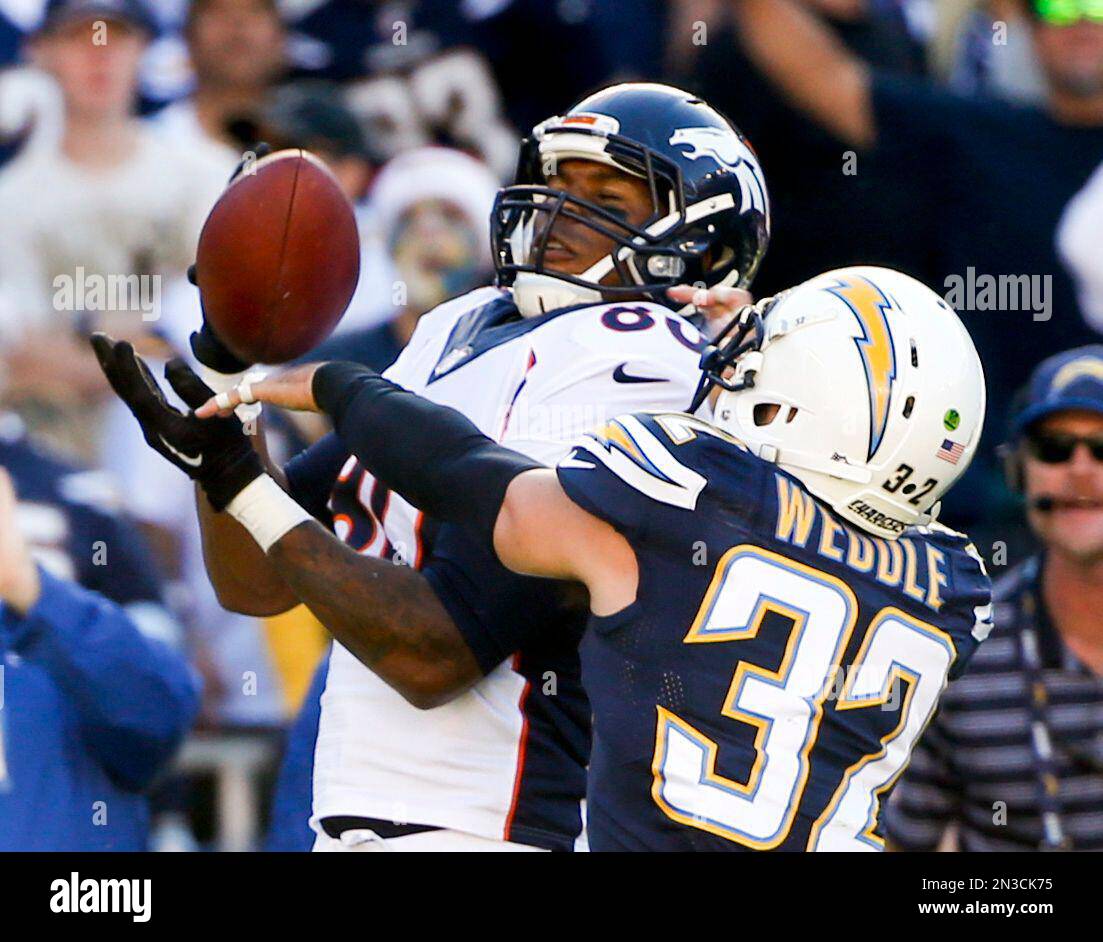 Denver Broncos tight end Julius Thomas, left, hauls in a pass under ...