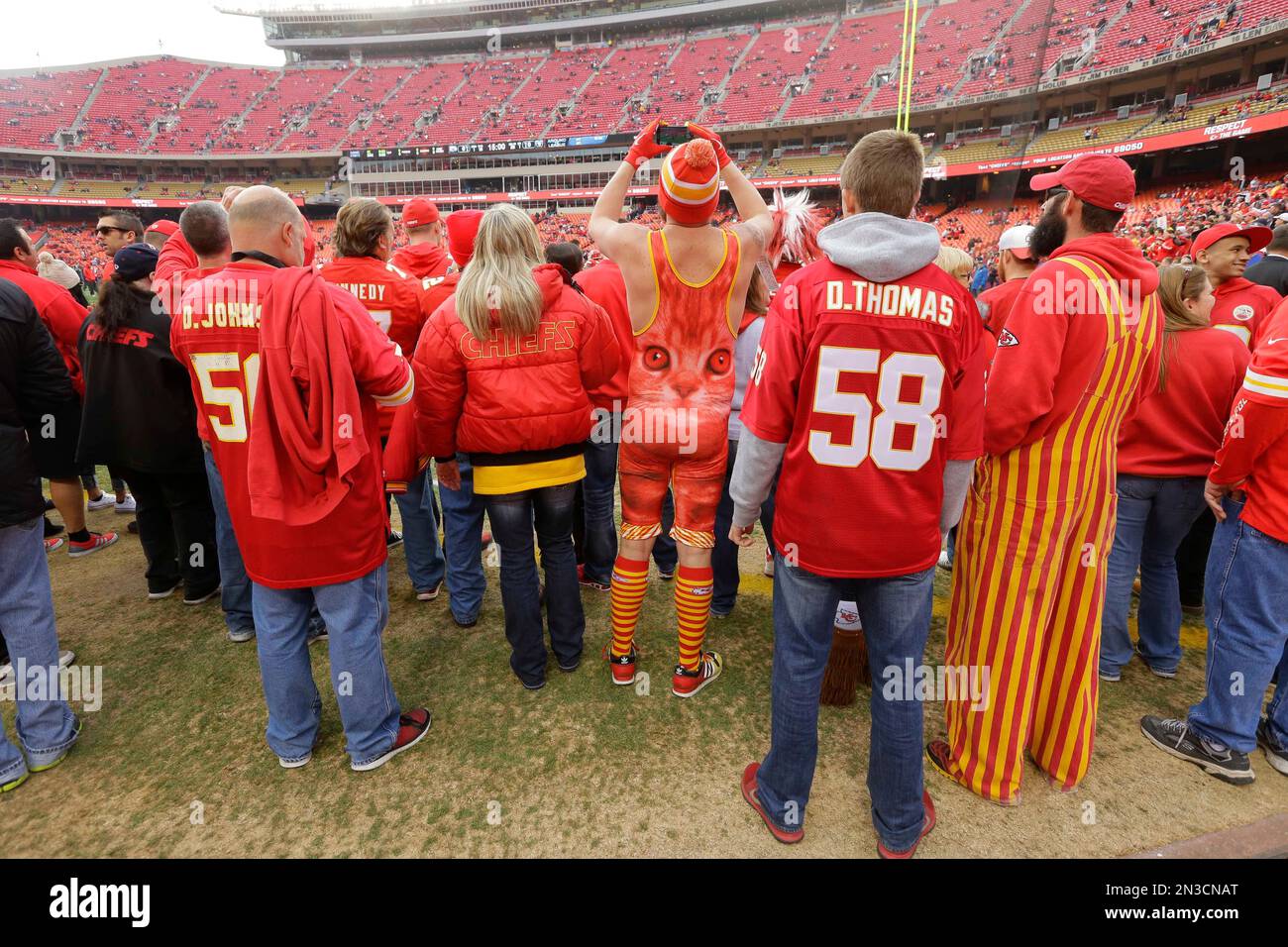 A Kansas City Chiefs fan wearing a cat outfit takes photos before an ...