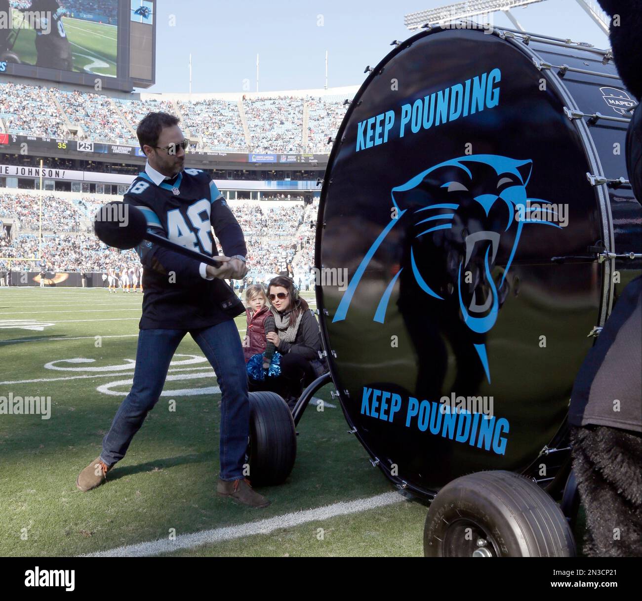 NASCAR driver Jimmie Johnson beats a drum before an NFL football game ...