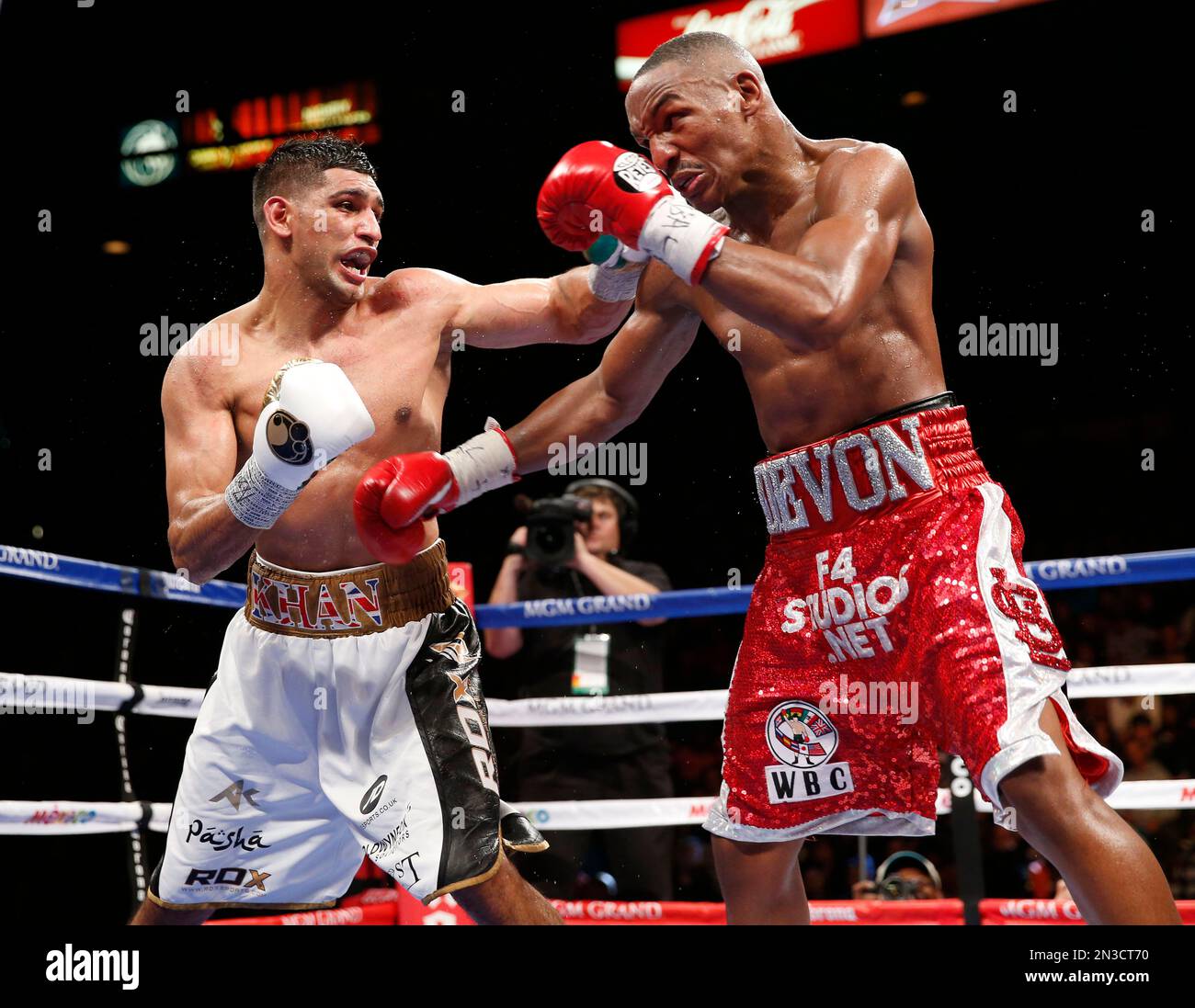 Amir Khan of Britain trades punches with Devon Alexander during their ...