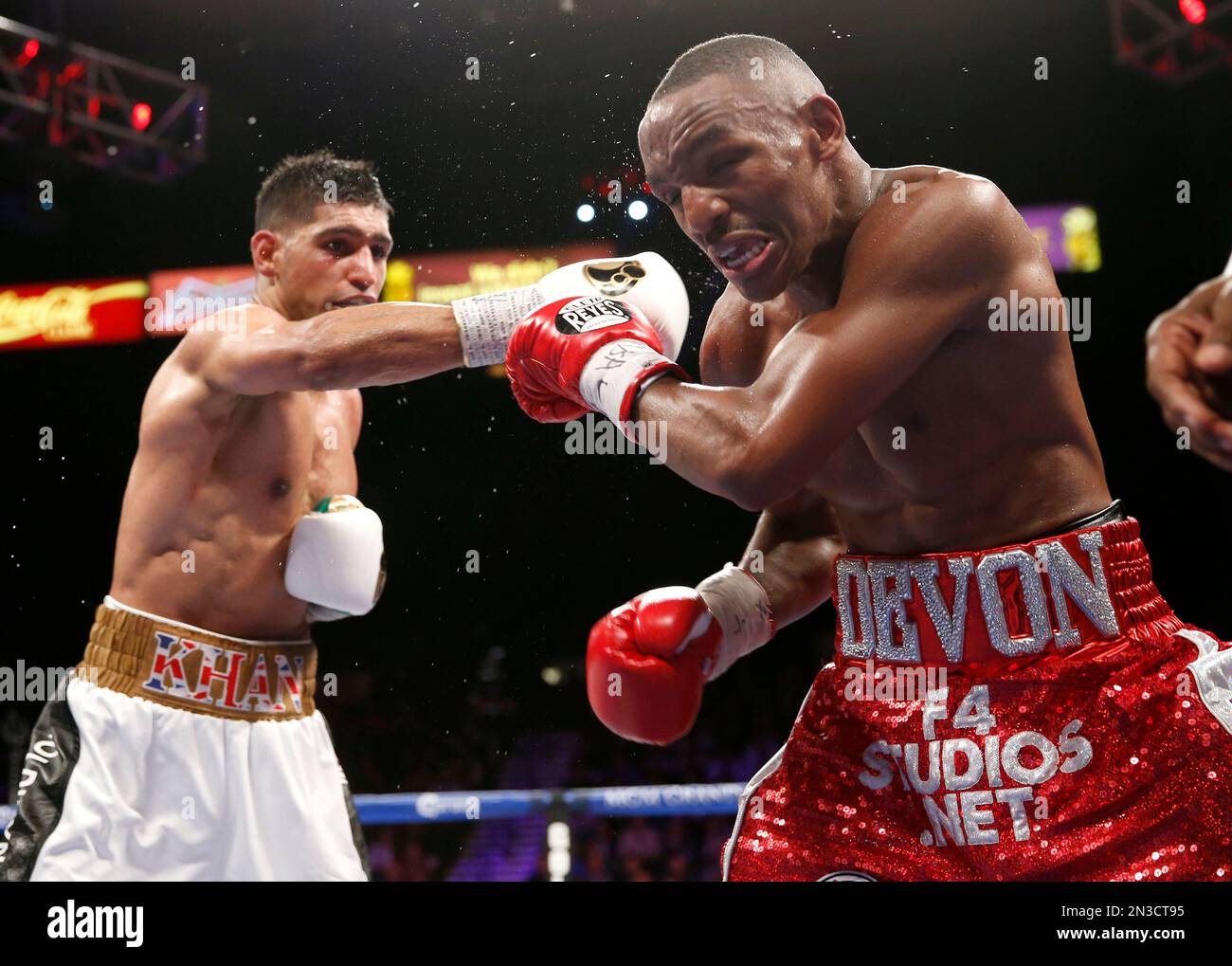 Amir Khan of Britain trades punches with Devon Alexander during their welterweight boxing match ...