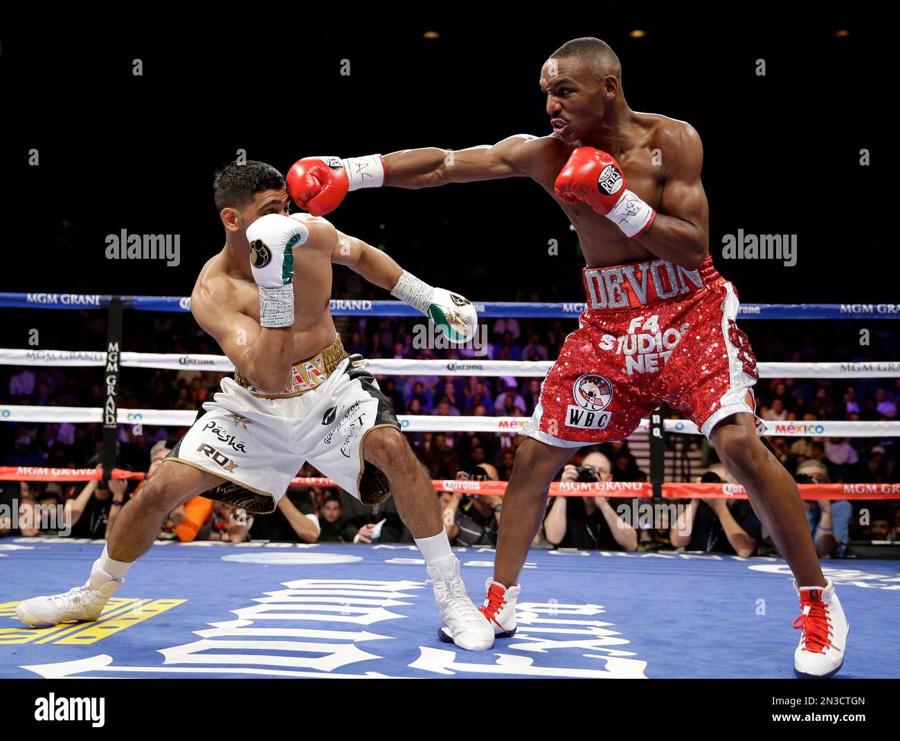 Devon Alexander throws a punch at Amir Khan during their welterweight ...