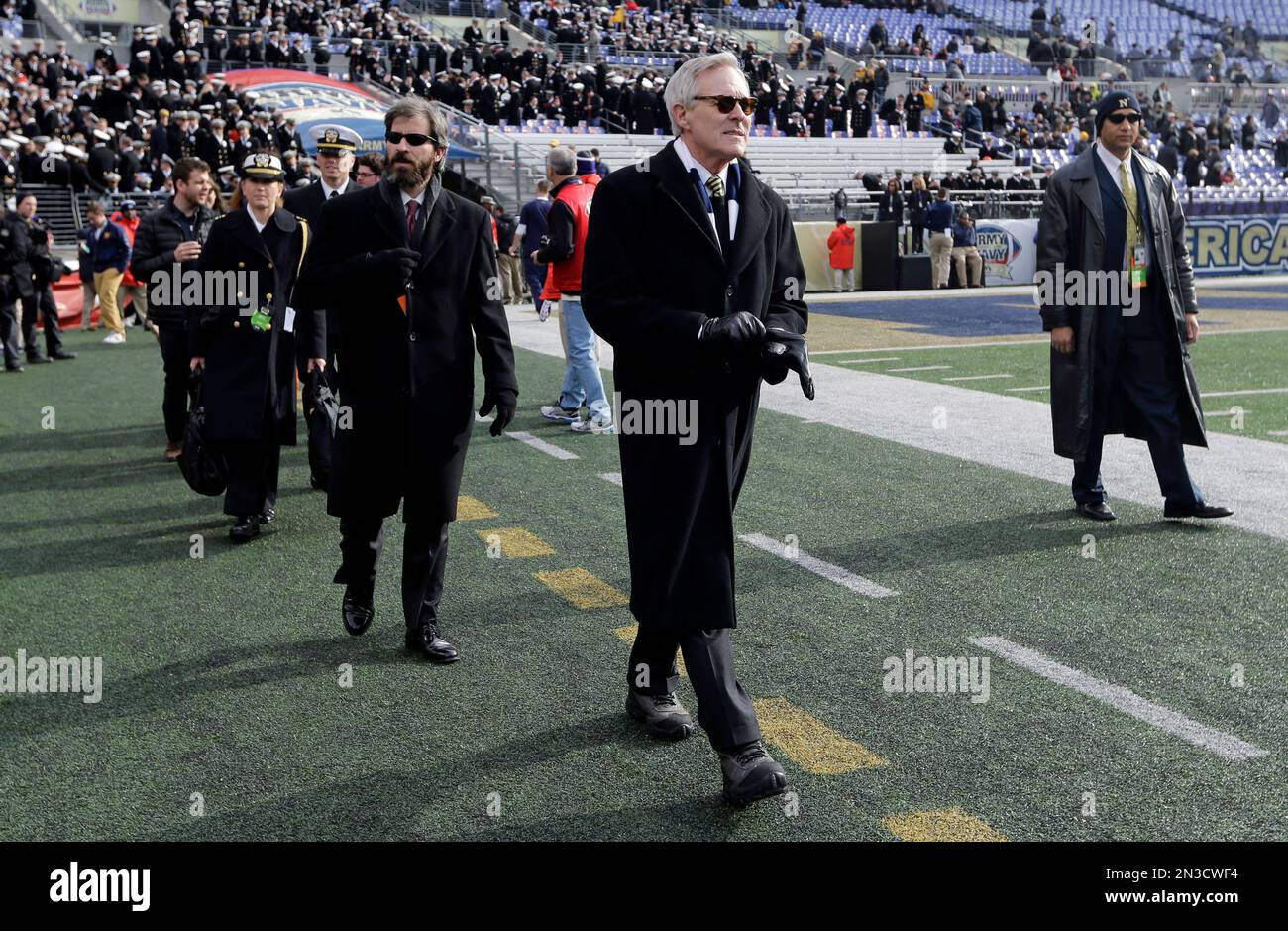 Navy Secretary Ray Mabus, center, walks on the field before the Army ...