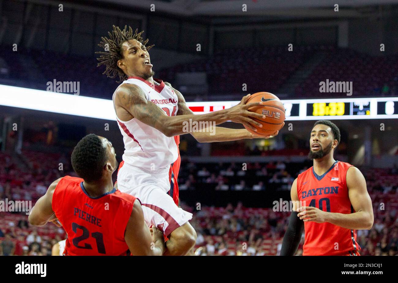 Arkansas guard Michael Qualls, center, drives through Dayton forward ...