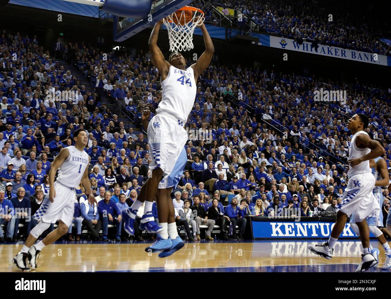 Kentucky's Dakari Johnson dunks near North Carolina's Joel James as ...