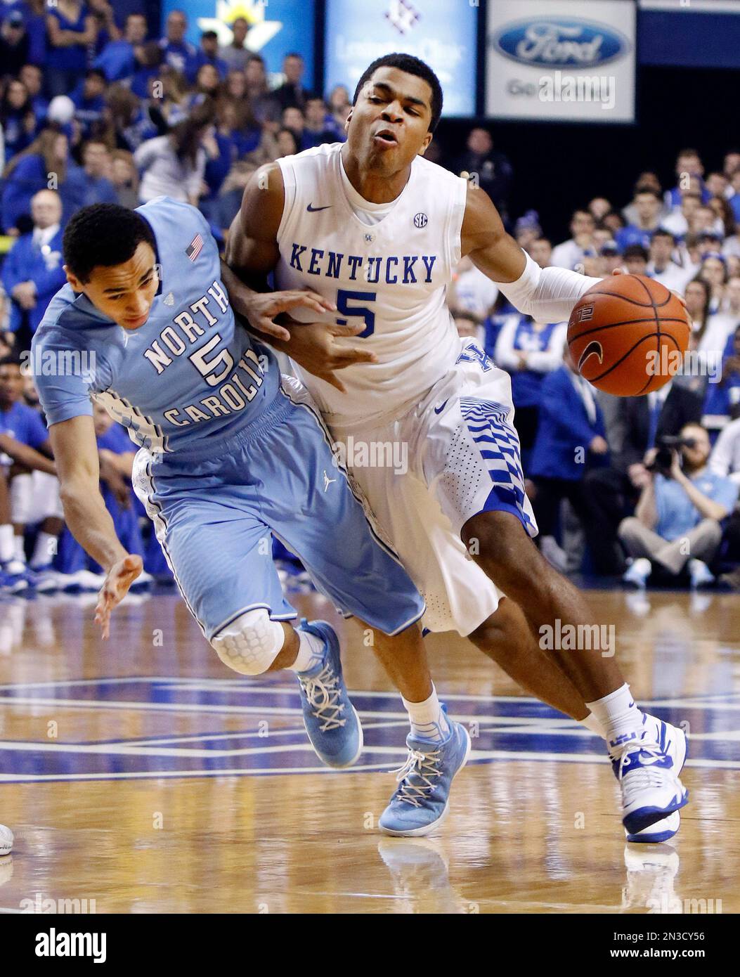 North Carolina's Marcus Paige, left, draws a charging foul on Kentucky ...
