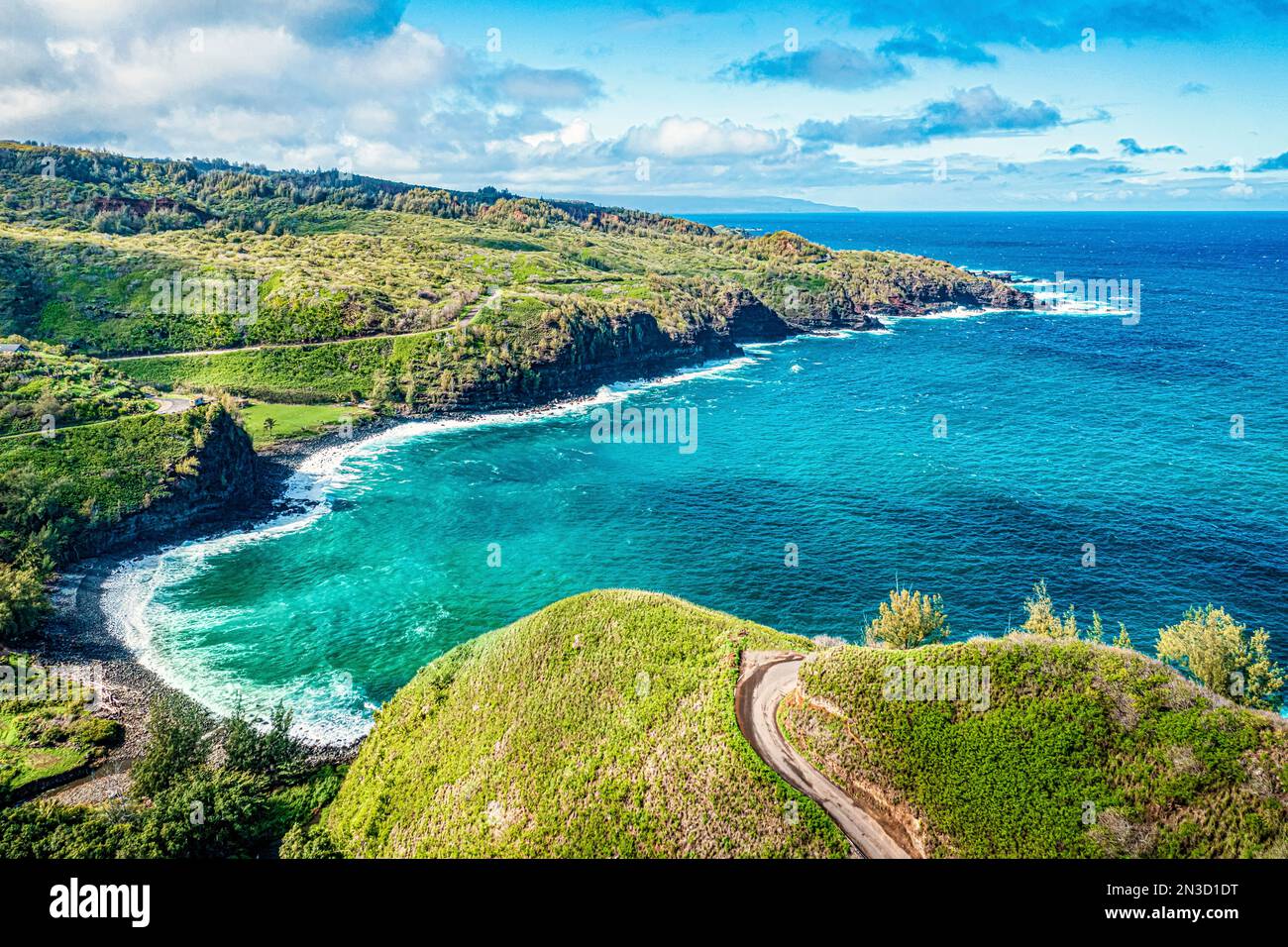 Coastal road and pathway along the hills with the Pacific Ocean surf ...