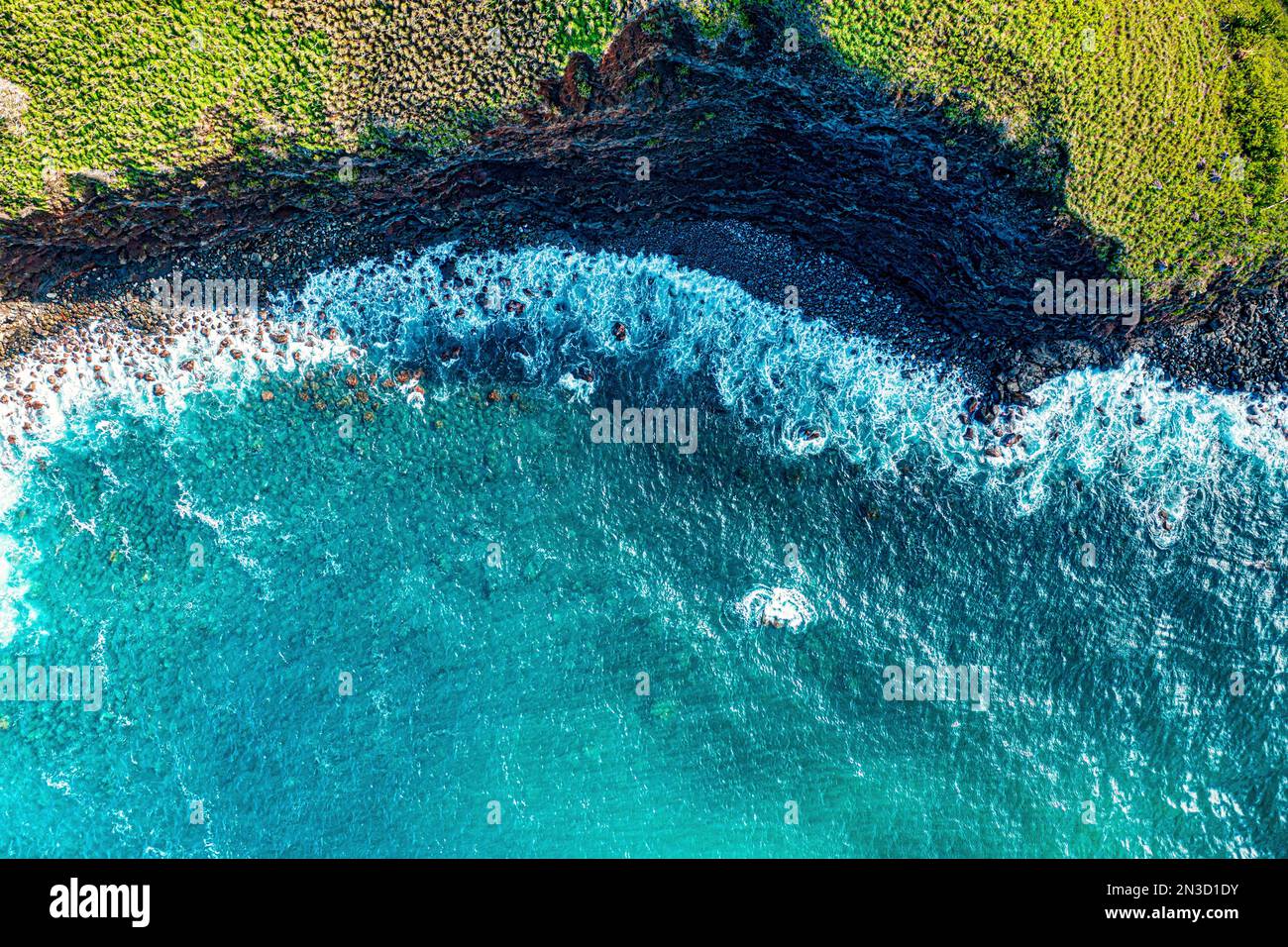 Aerial view from directly above of the rugged coastline and turquoise ...