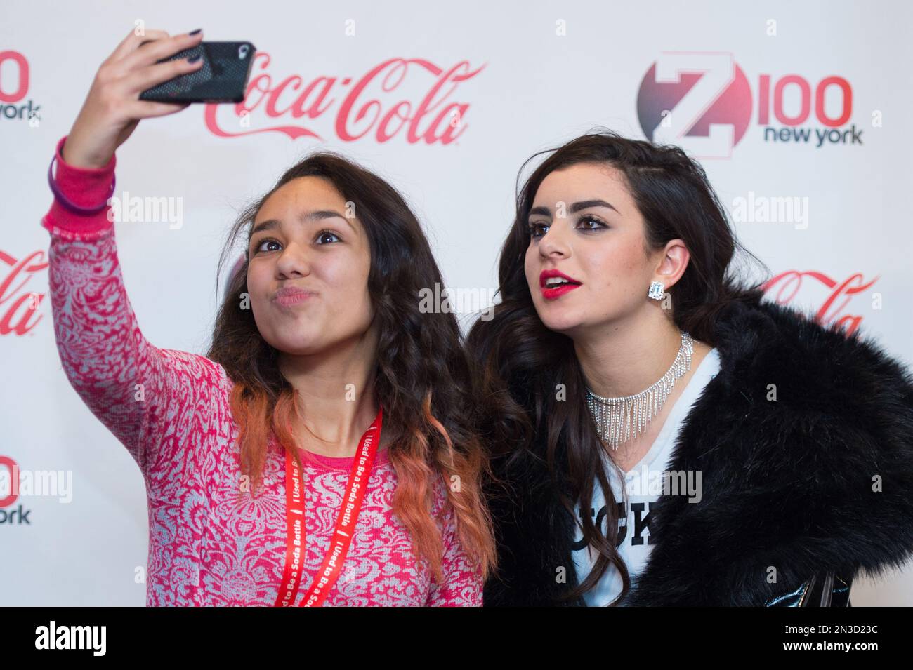 Charli XCX and a fan pose for a selfie at Z100's Jingle Ball All Access ...