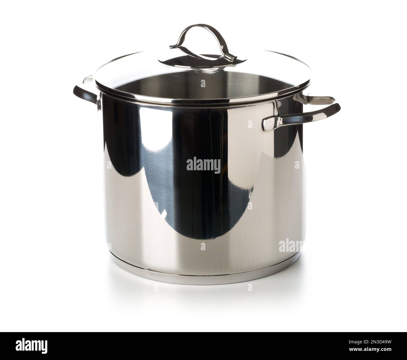 Large stainless steel cooking pot with glass lid on top elevated view ...
