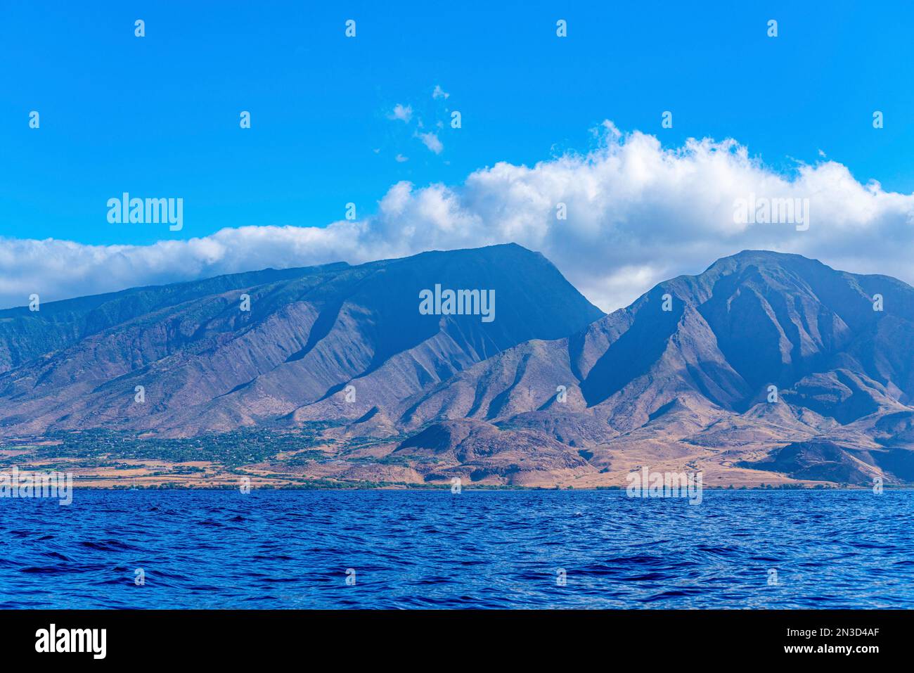 Bright blue waters of the Pacific Ocean and the undulating ridges of ...