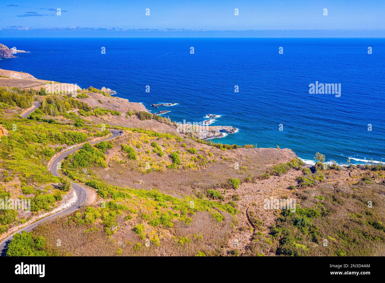 Aerial view of a winding roadway and the rugged coastline of Waihee ...