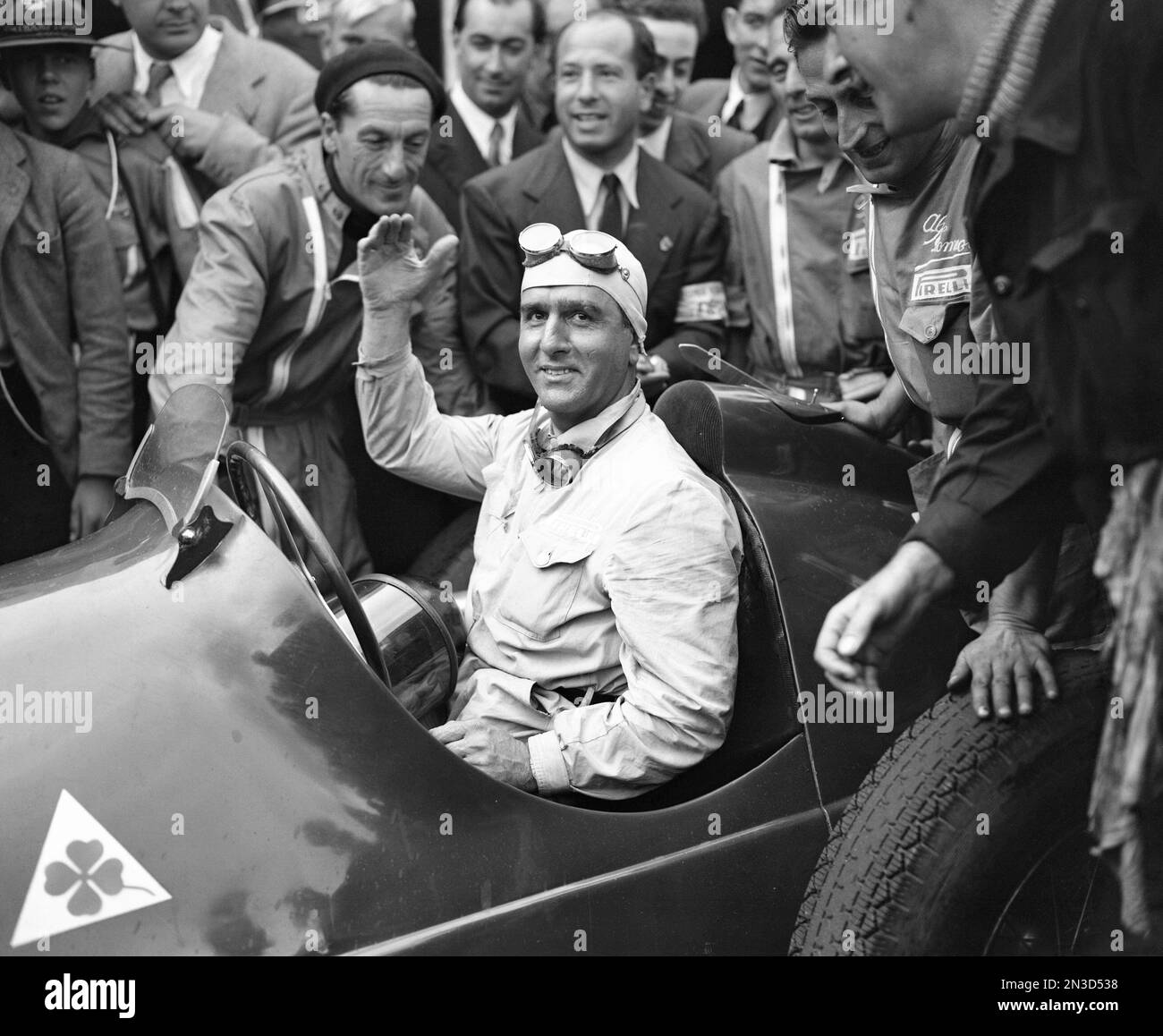 Giuseppe Farina smiles as he waves from his Alfa Romeo car after ...