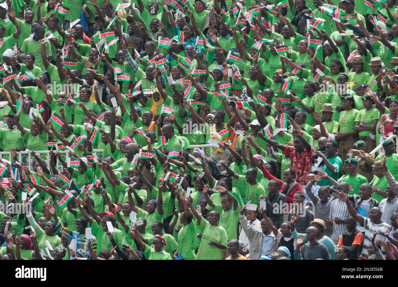 Part of the crowd holding Kenyan flags cheer as Kenyan President ...