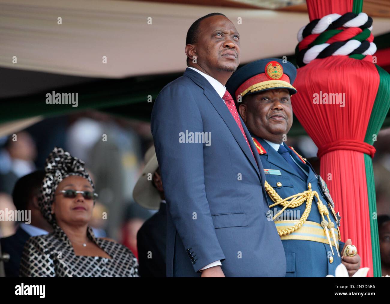 Kenyan President, Uhuru Kenyatta, middle, and Chief of Defence Forces Julius Karangi, right, and ...
