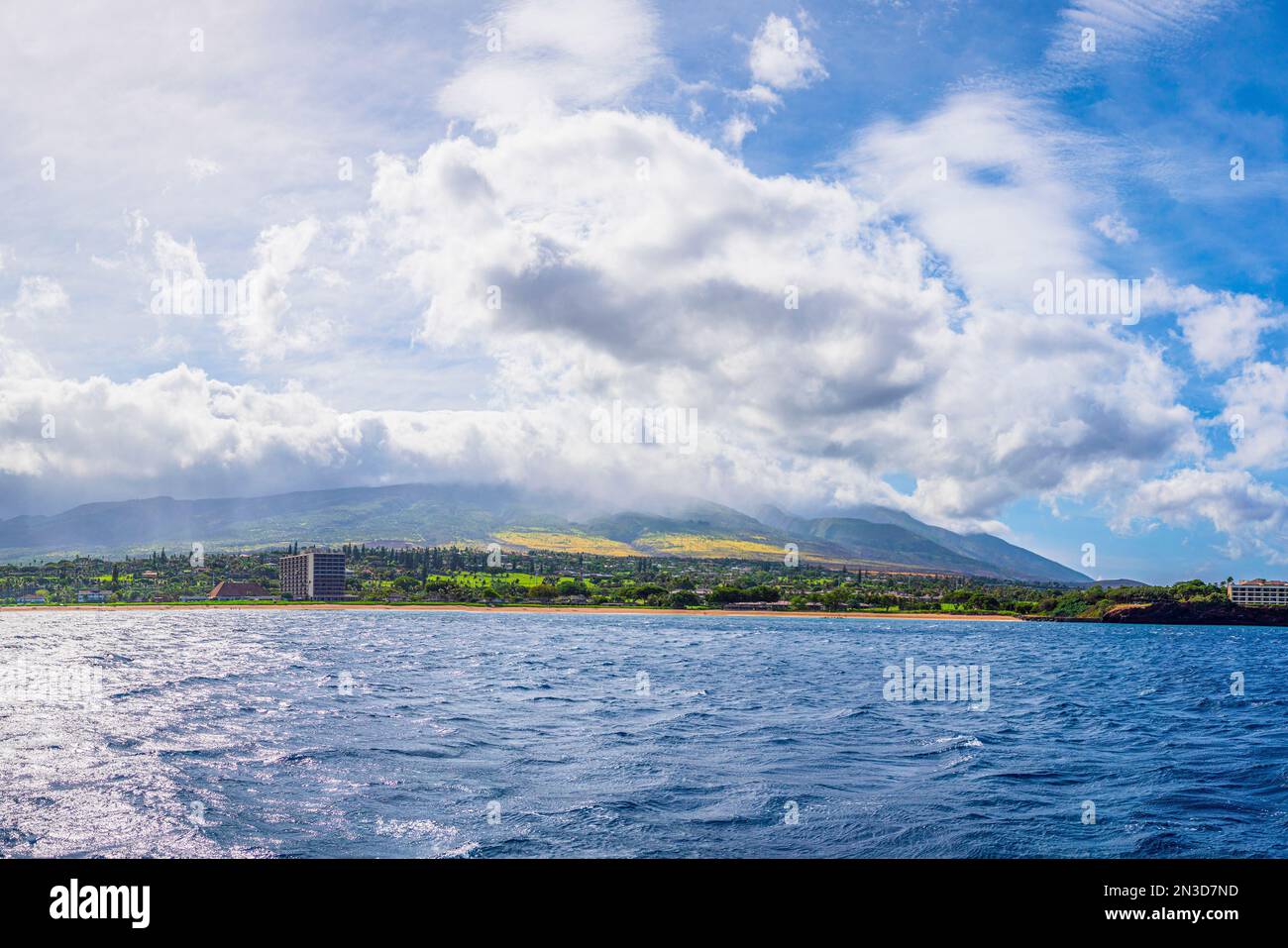 Coastal cityscape along the shoreline of the Island of Maui with rain ...