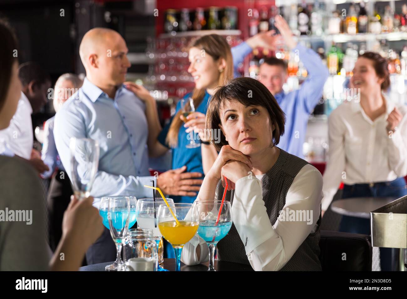 Woman bored at corporate party Stock Photo - Alamy