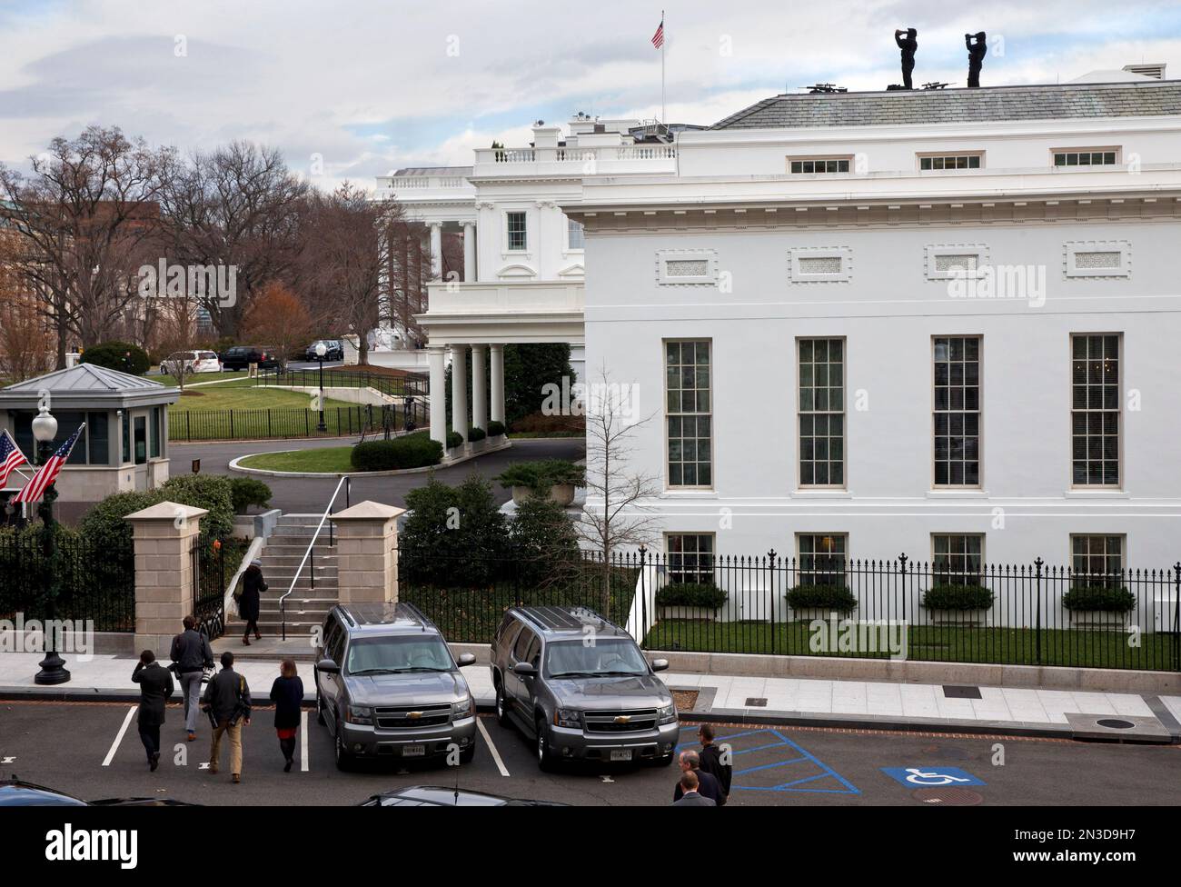 U.S. Secret Service agents from the Counter Sniper Division work on top ...