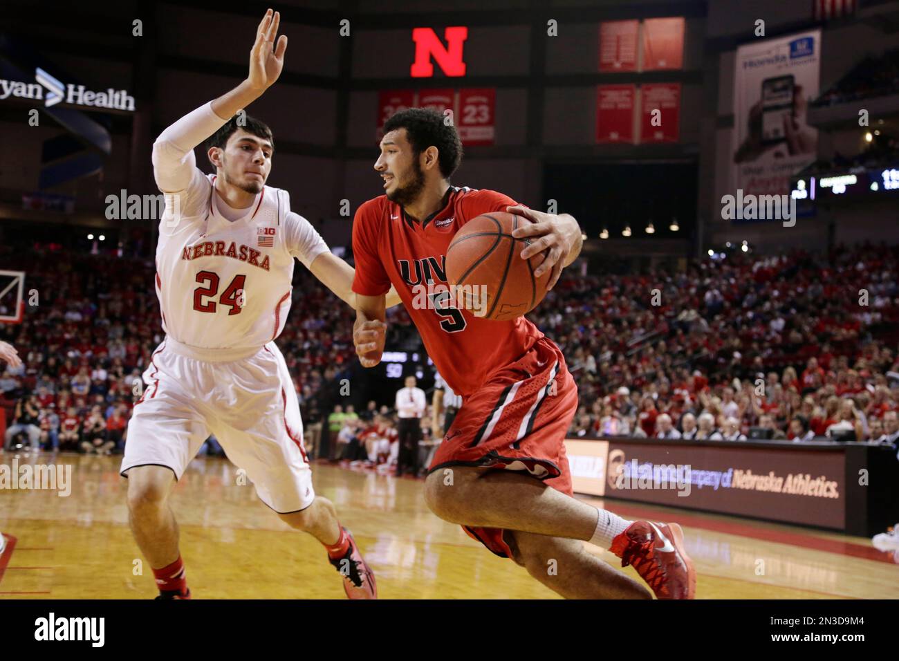Incarnate Word's Traylin Farris (5) drives past Nebraska's Jake Hammond ...