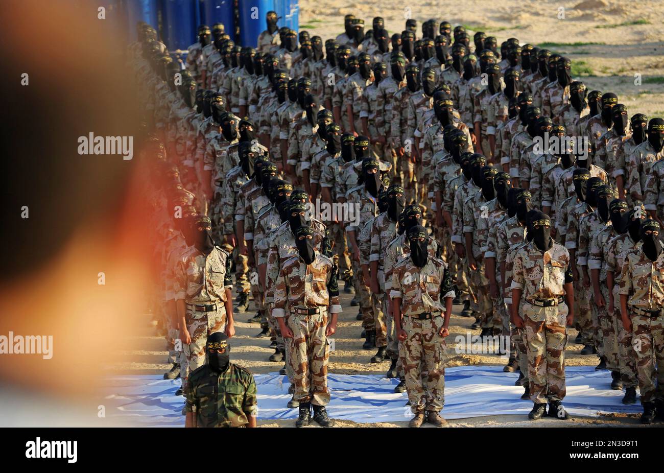 Palestinian militants of the Islamic Jihad group take part in their ...