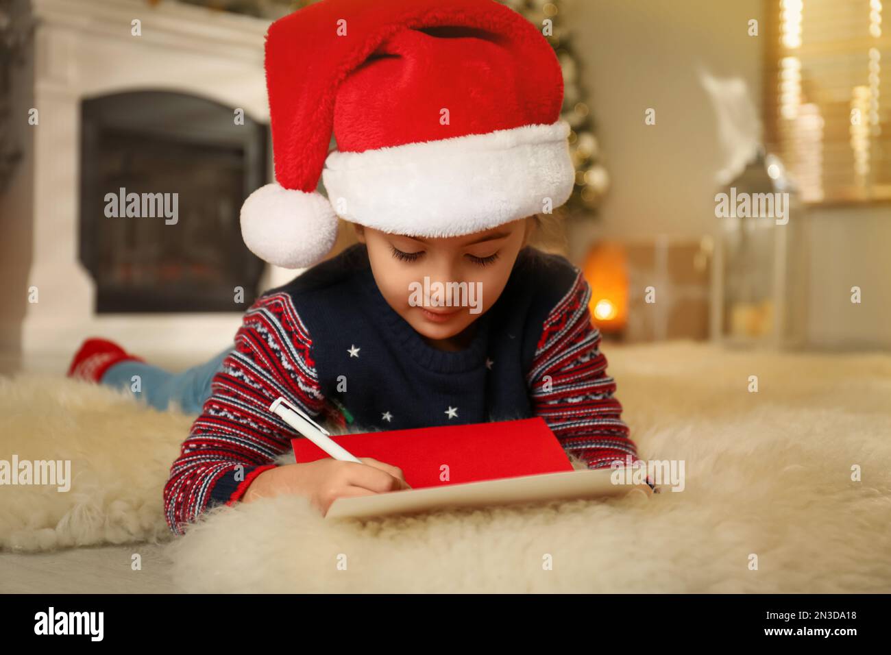 Cute child writing letter to Santa Claus at home. Christmas tradition ...