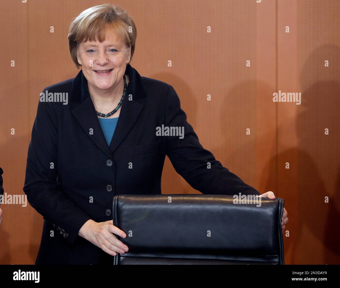 German Chancellor Angela Merkel smiles as she arrives for the weekly ...