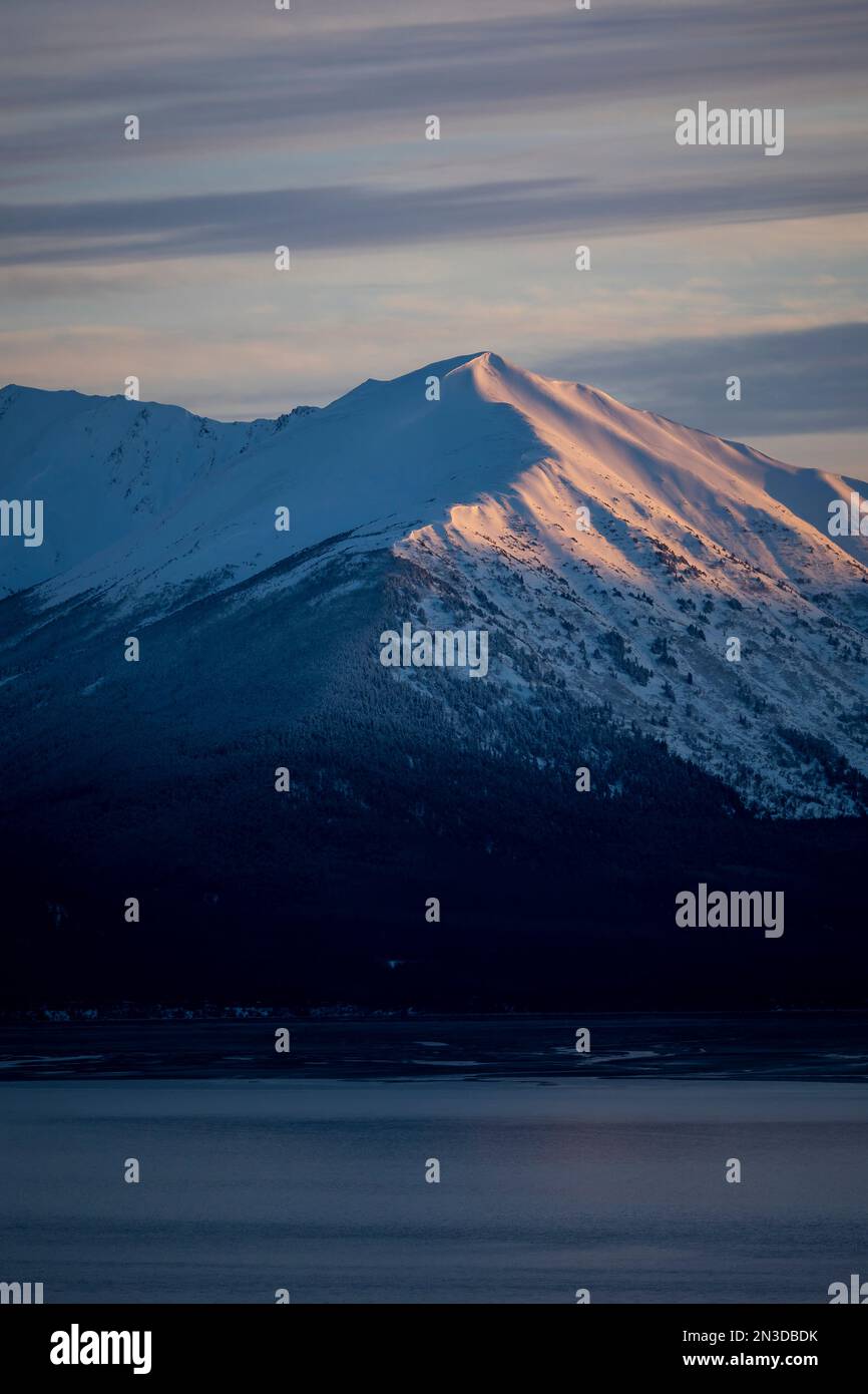Sunset reflecting on the snow-covered mountaintop at Turnagain Arm ...