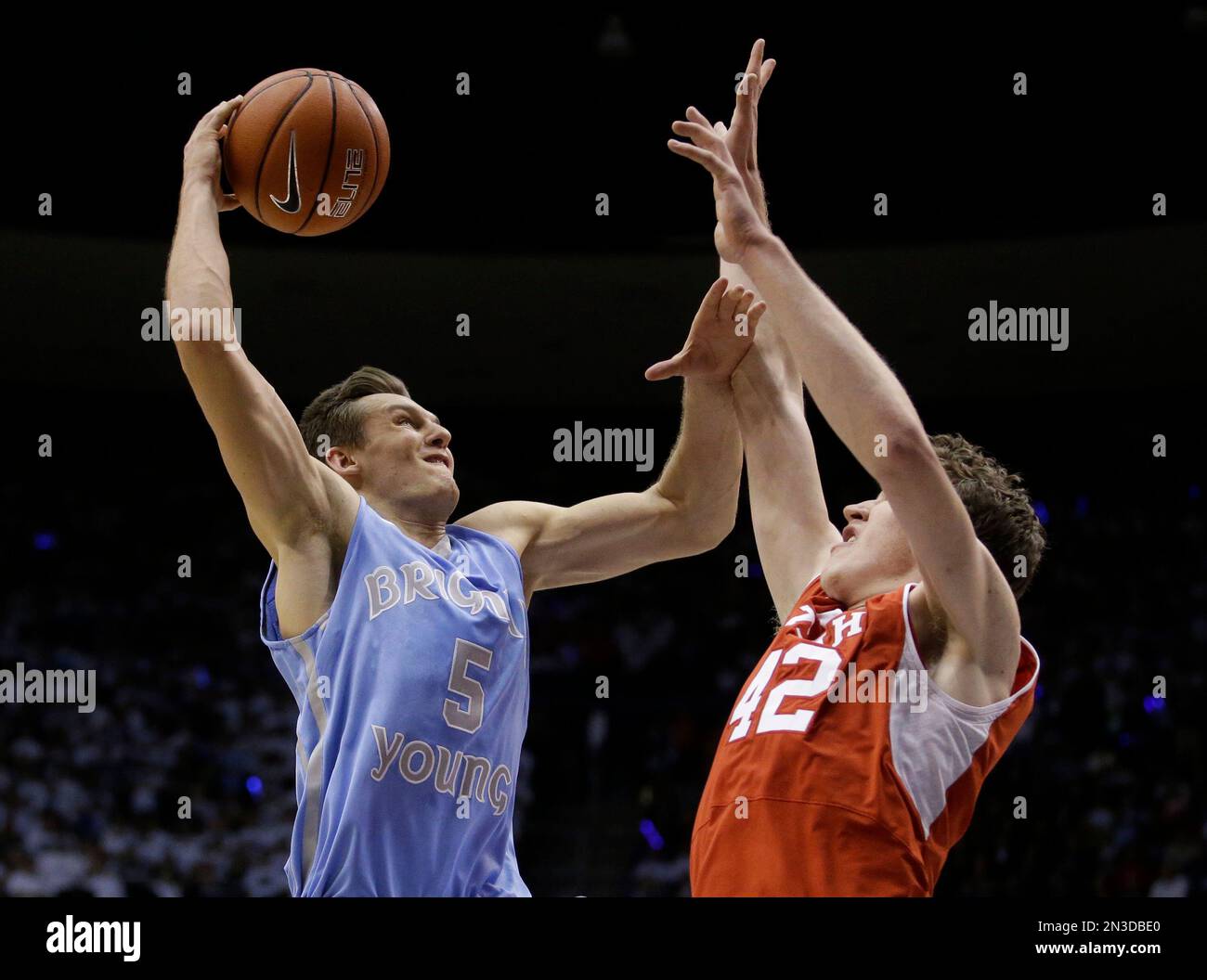 BYU guard Kyle Collinsworth (5) shoots as Utah forward Jakob Poeltl (42 ...
